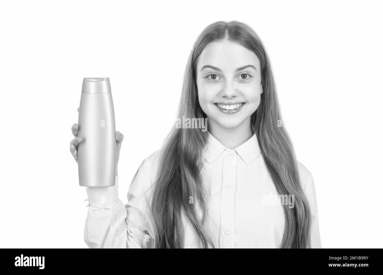 happy kid presenting shampoo or hair body conditioner bottle isolated ...