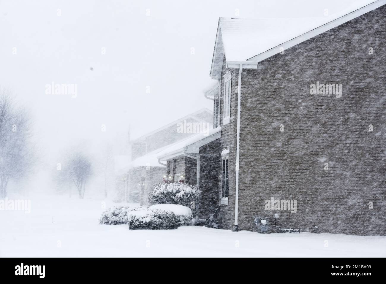 A blizzard in suburban Chicago neighborhood with blowing and drifting ...
