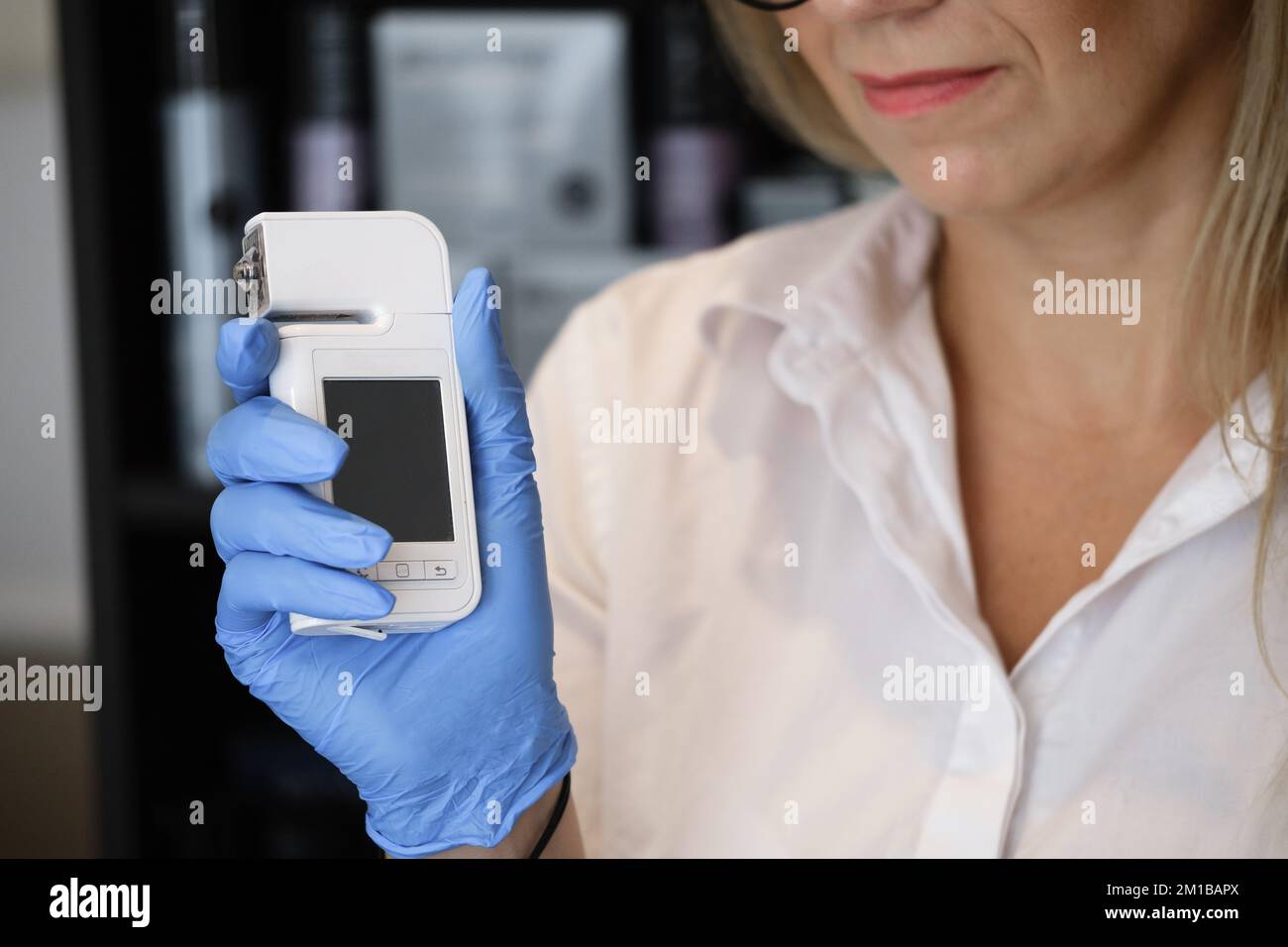 Hands holding special dermatology equipment system, hair loss and ...