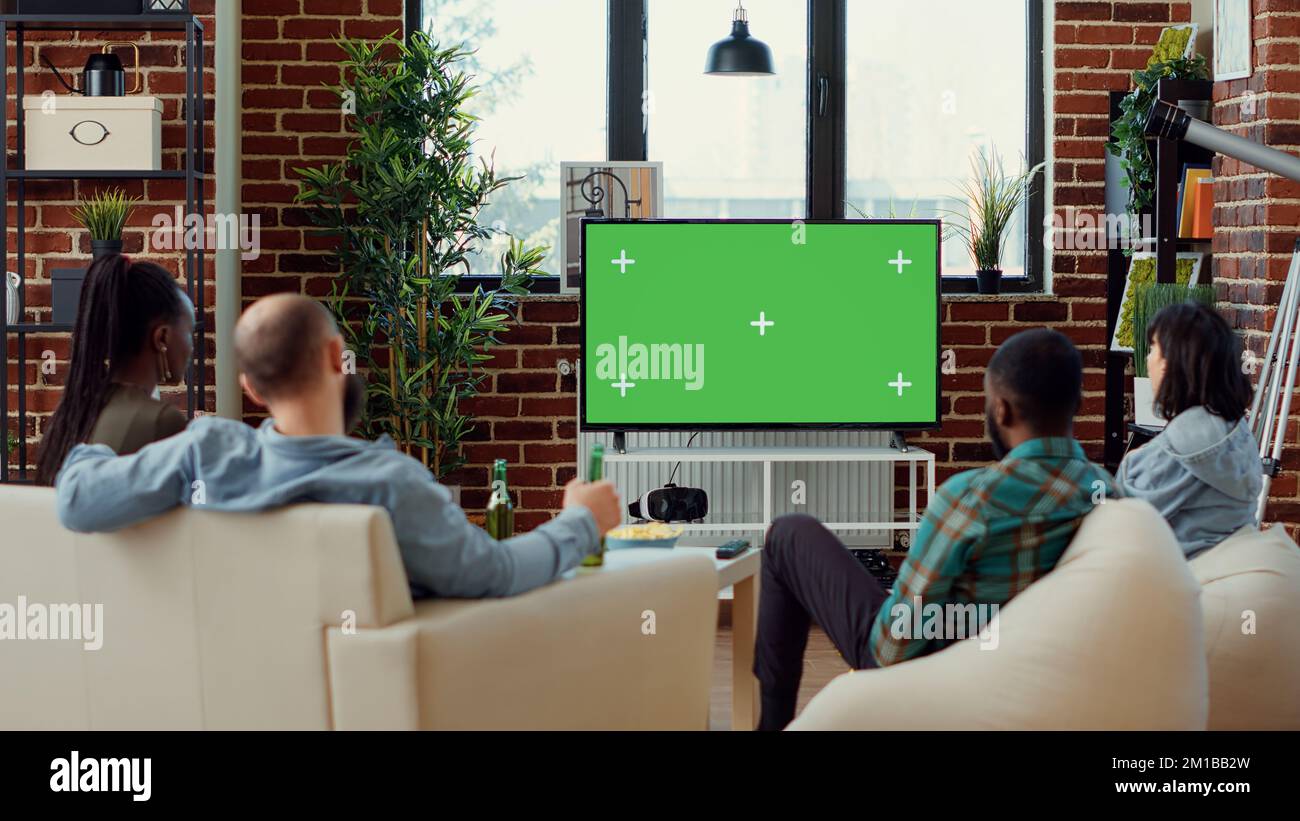 Diverse friends watching tv series on greenscreen template, using ...