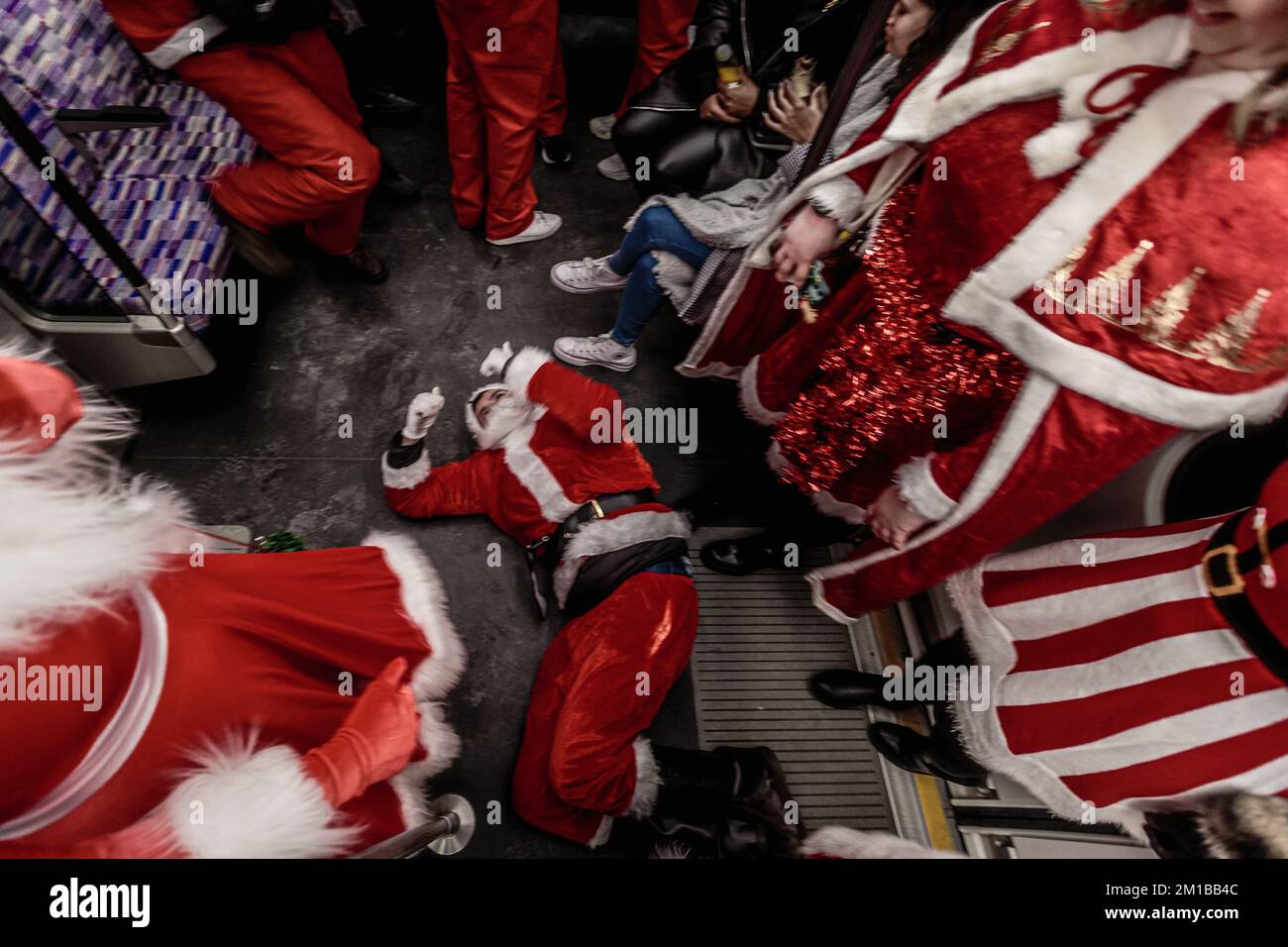 Santacon fun on a train in London Stock Photo - Alamy