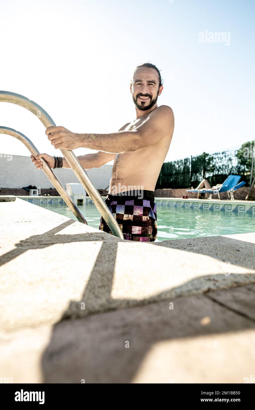 Man entering a pool hi-res stock photography and images - Alamy