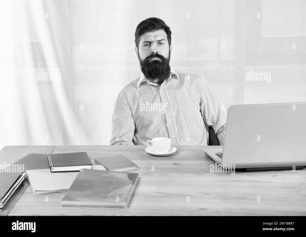 Serious guy working at office desk. Office work Stock Photo - Alamy