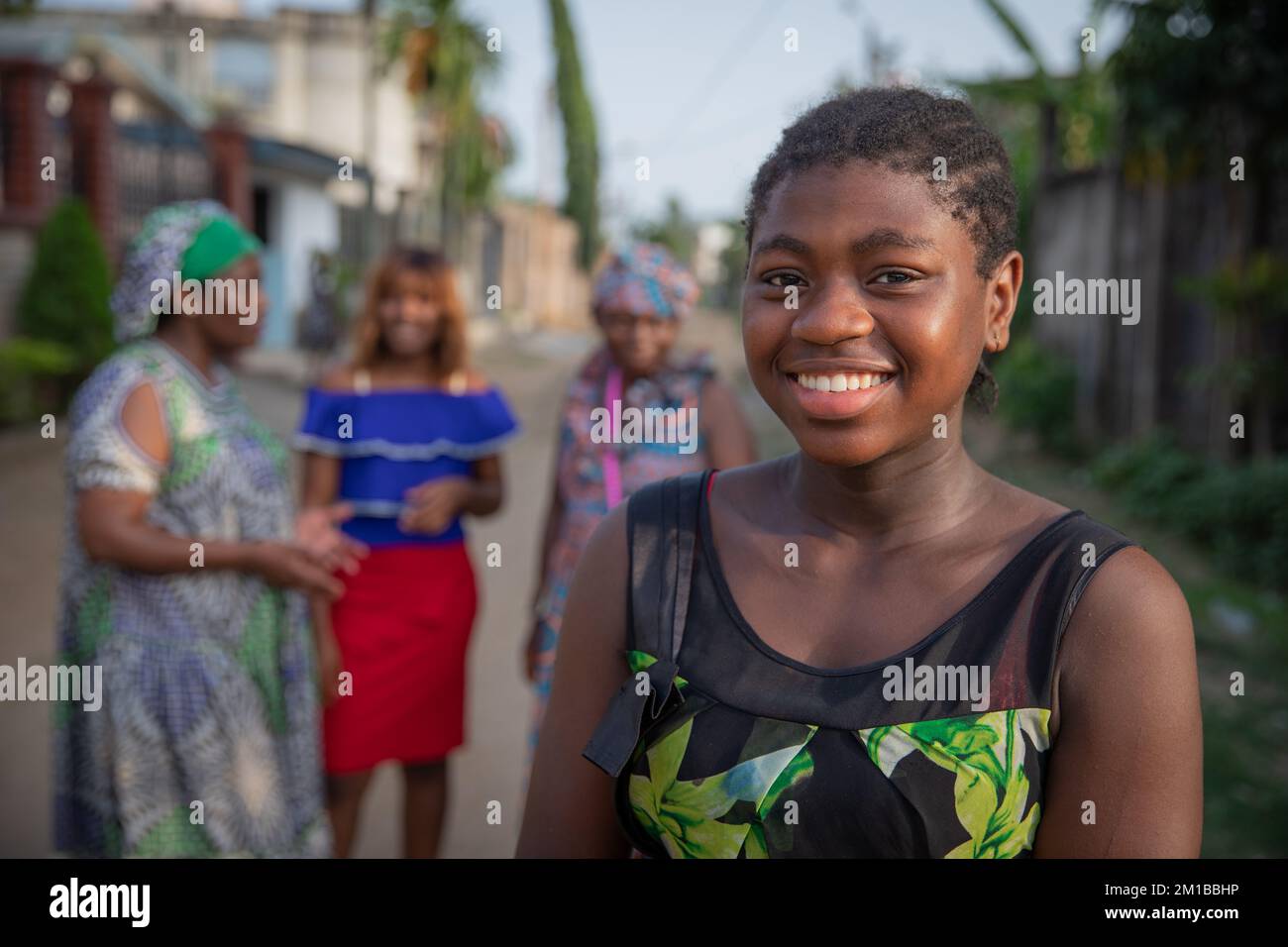 Portrait of a young African girl with other African women of different ...