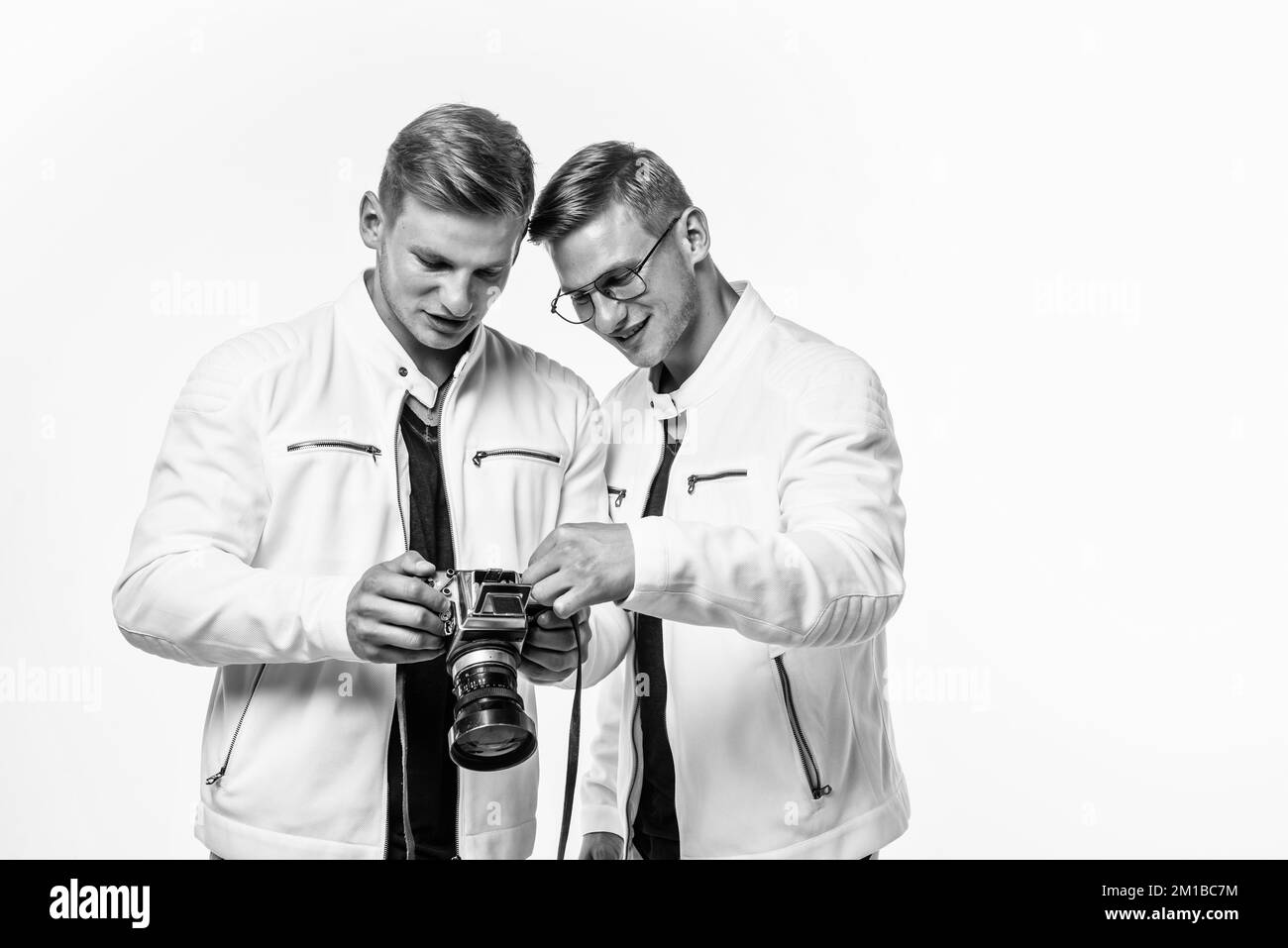two cousin with retro photo camera. young confident brothers. confident ...