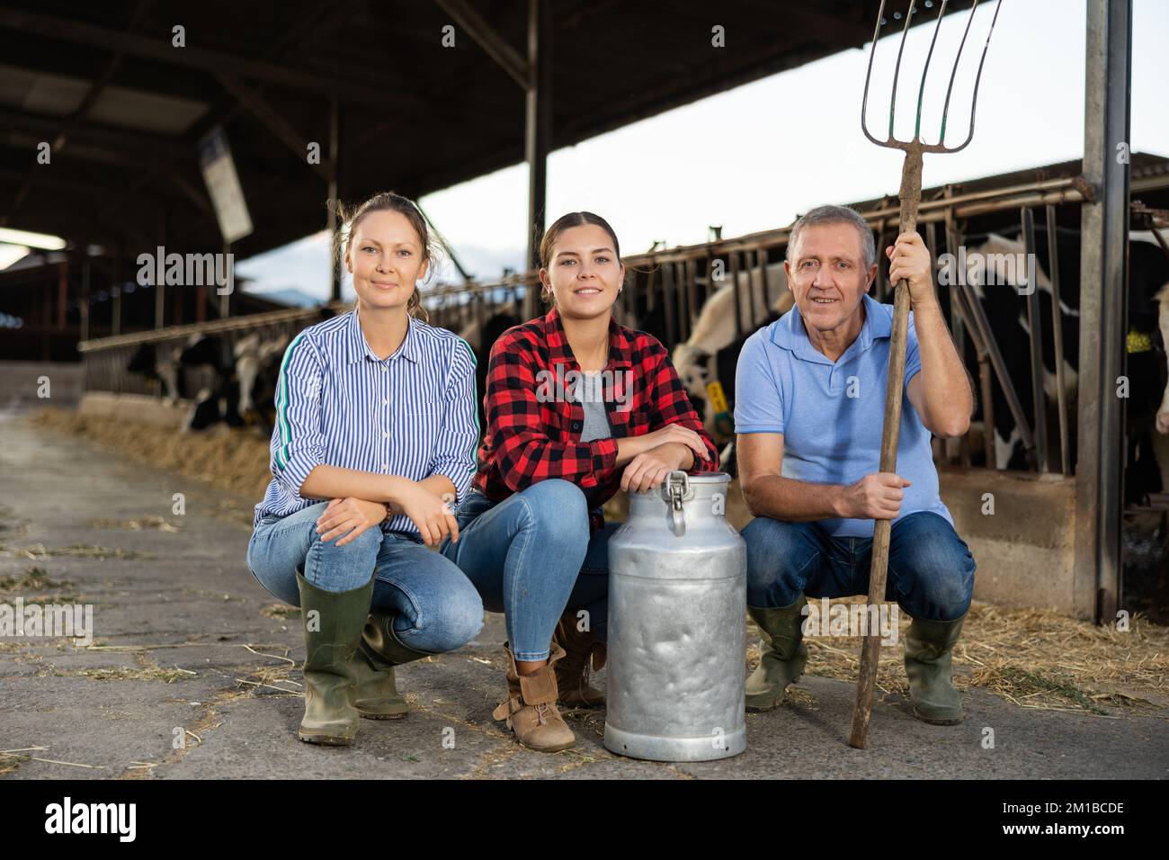 Group photo of positive cow farm workers Stock Photo - Alamy