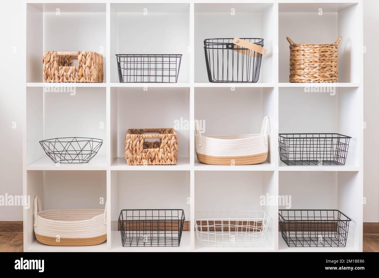 White stylish shelf in scandi style. Storage baskets. Japanese method ...