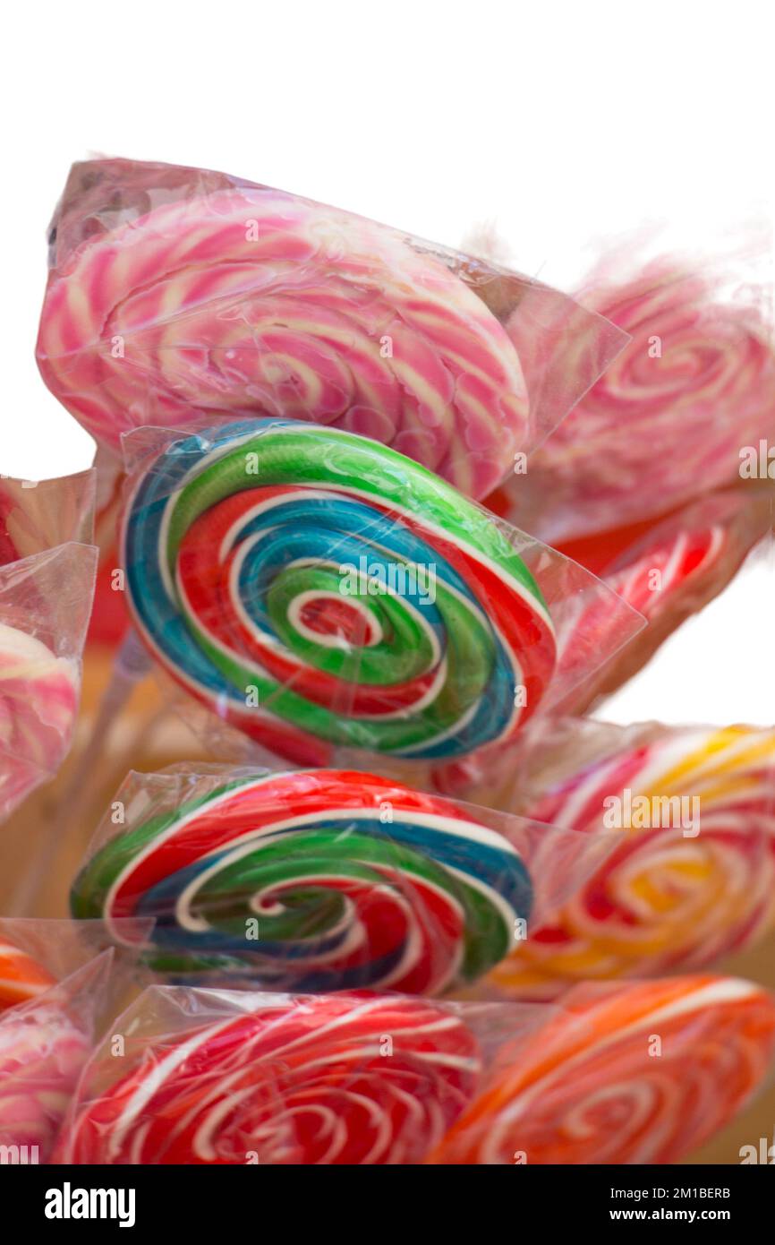 Colorful spiral lollipop of different colors round candies. Colorful ...