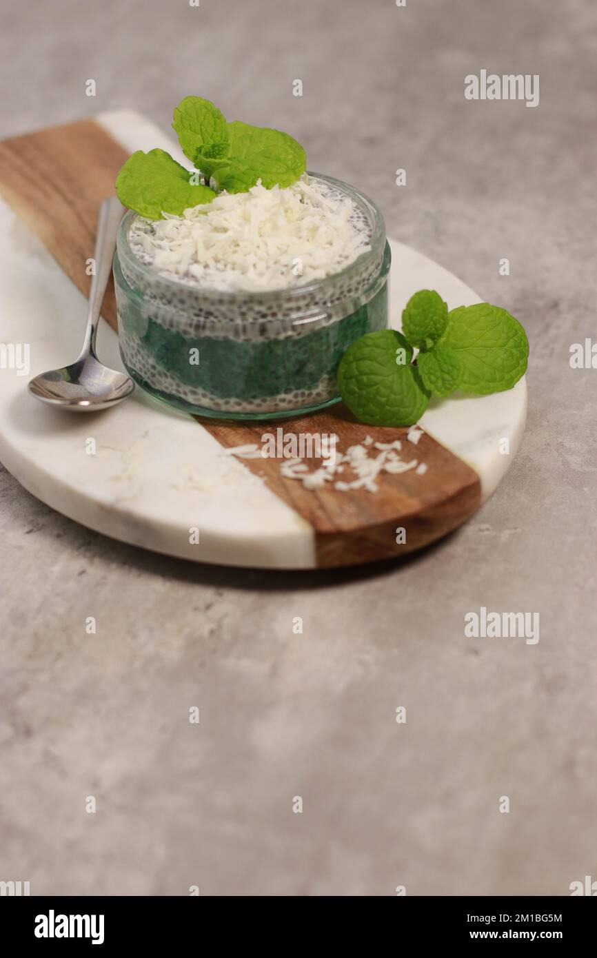 delicious vegan coconut chia pudding with mint, on white table Stock ...