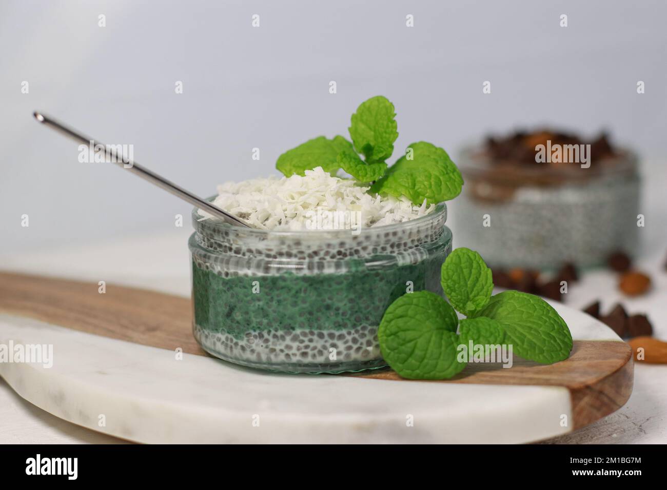 delicious vegan coconut chia pudding with mint, on white table Stock ...