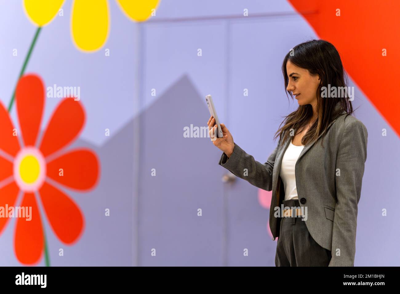 Side view of positive young female manager with long dark hair in ...