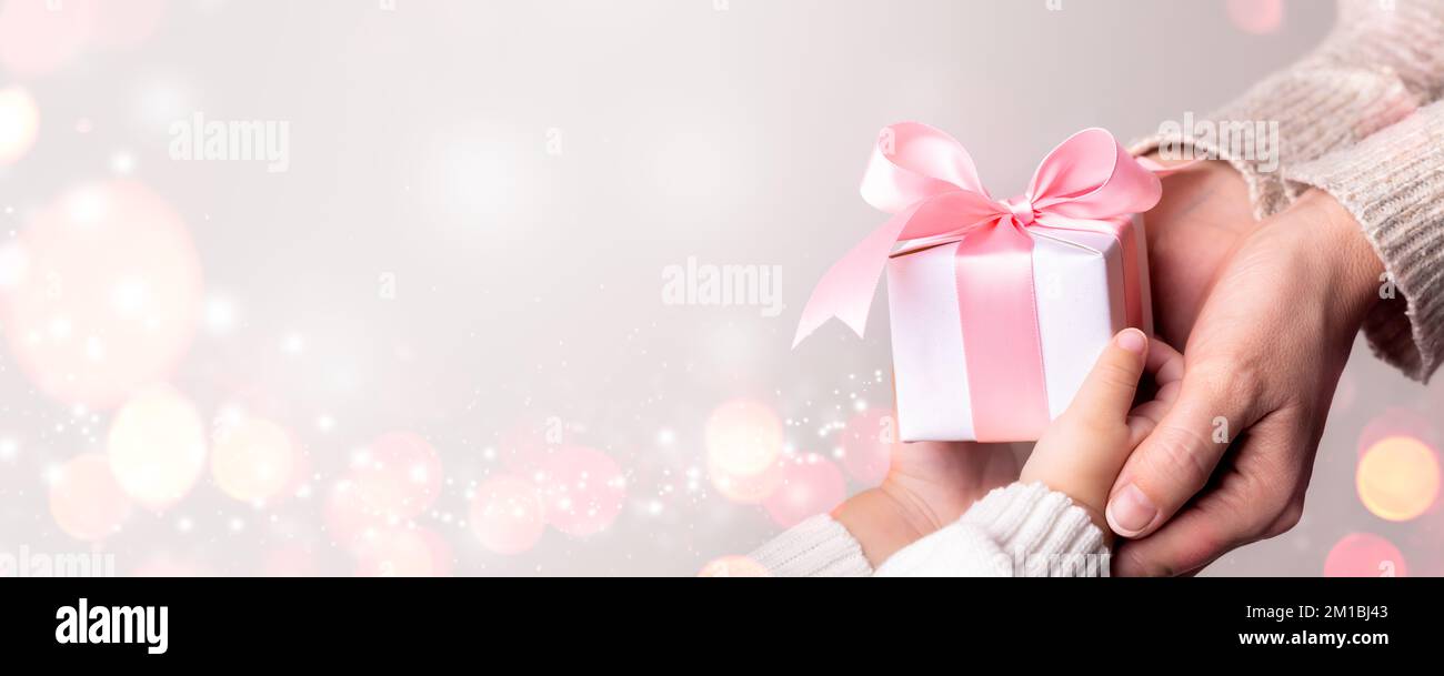 Hands Of Child Giving Gift Box With Pink Ribbon To Mother - Happy ...