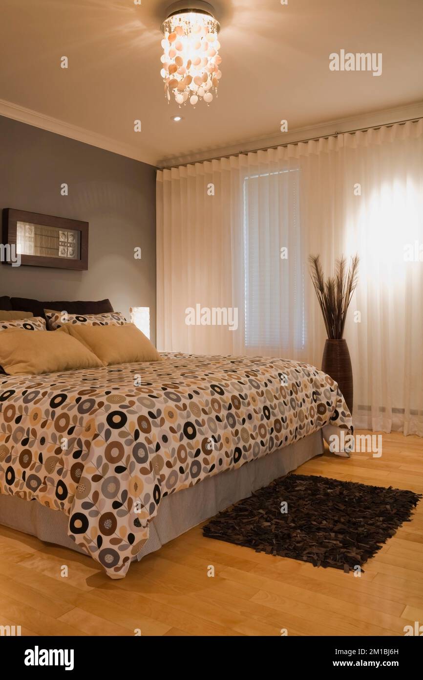 King size bed with flowery motifs bedspread in master bedroom inside ...