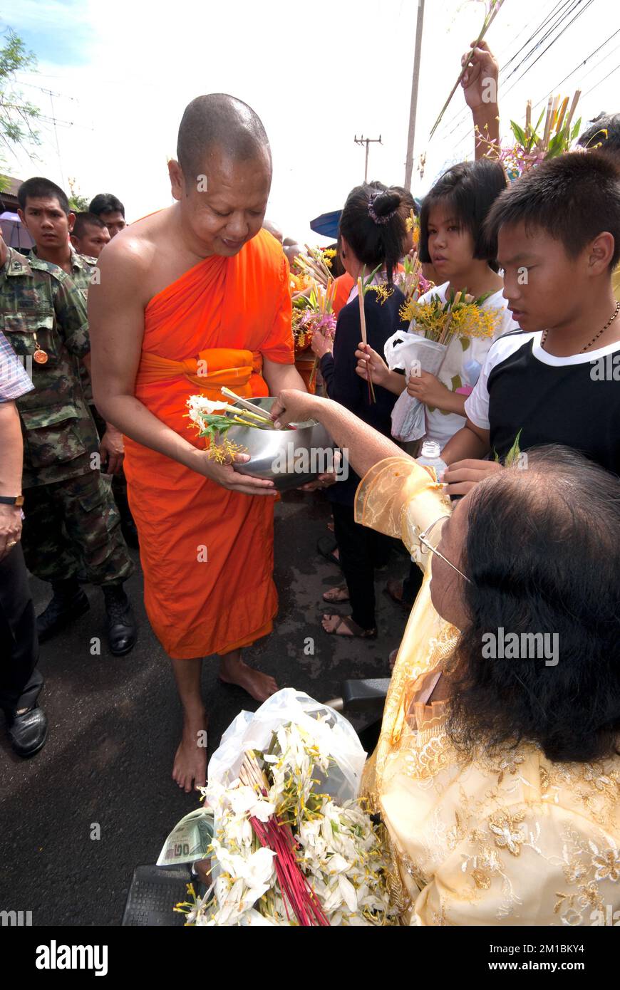 Many Thai people Give Flowers to Buddhist Monks for alms in The Tak Bat ...