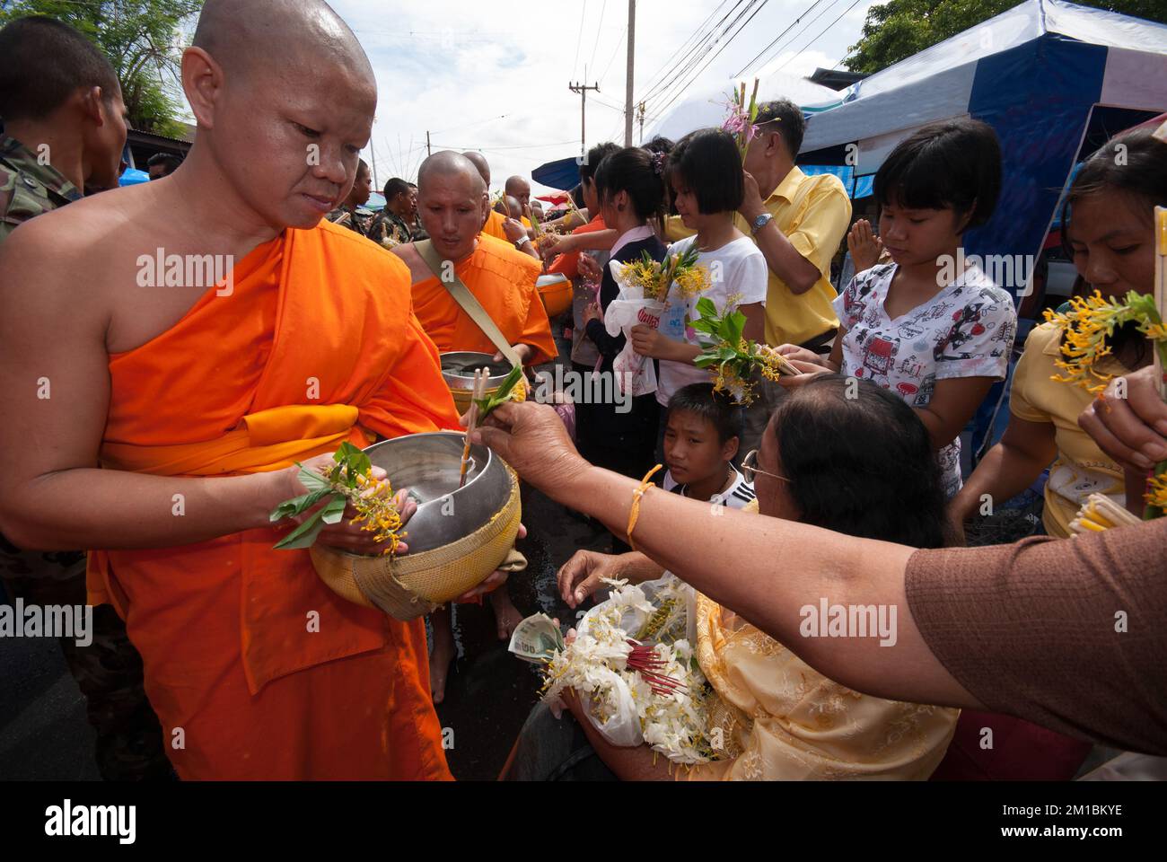 Many Thai people Give Flowers to Buddhist Monks for alms in The Tak Bat ...