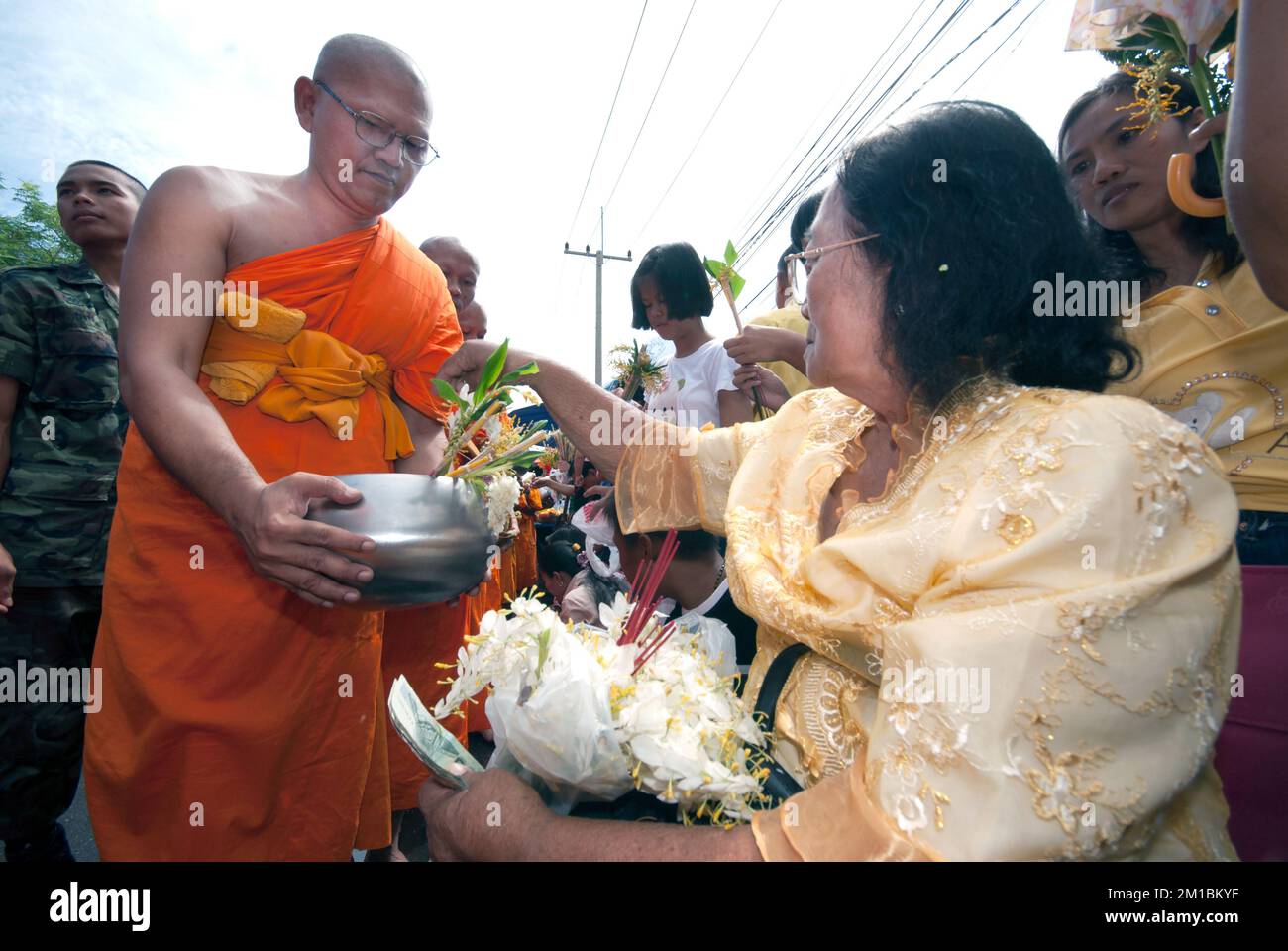 Many Thai people Give Flowers to Buddhist Monks for alms in The Tak Bat ...