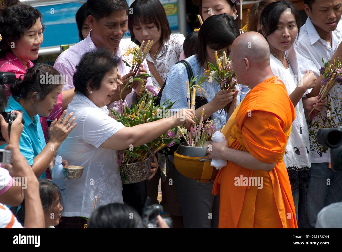 Many Thai people Give Flowers to Buddhist Monks for alms in The Tak Bat ...