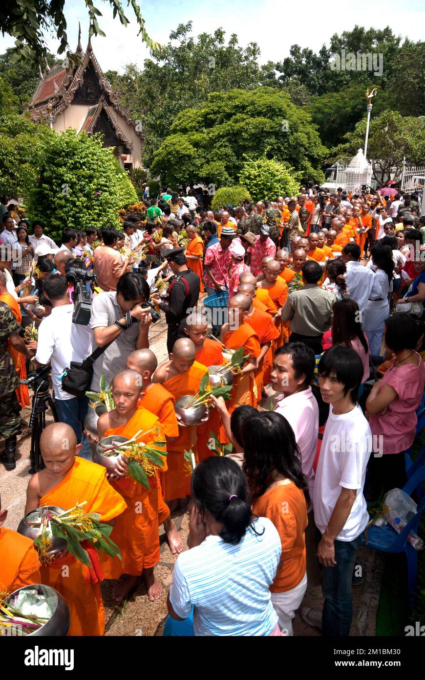 Many Thai people Give Flowers to Buddhist Monks for alms in The Tak Bat ...