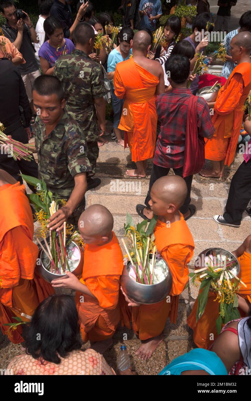 Many Thai people Give Flowers to Buddhist Monks for alms in The Tak Bat ...