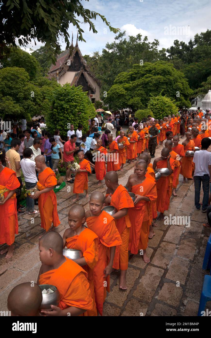 Many Thai people Give Flowers to Buddhist Monks for alms in The Tak Bat ...