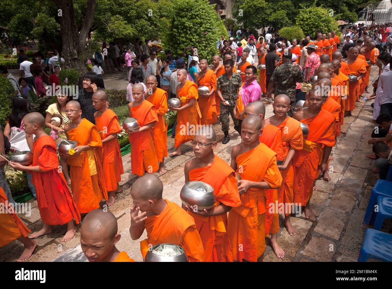 Many Thai people Give Flowers to Buddhist Monks for alms in The Tak Bat ...