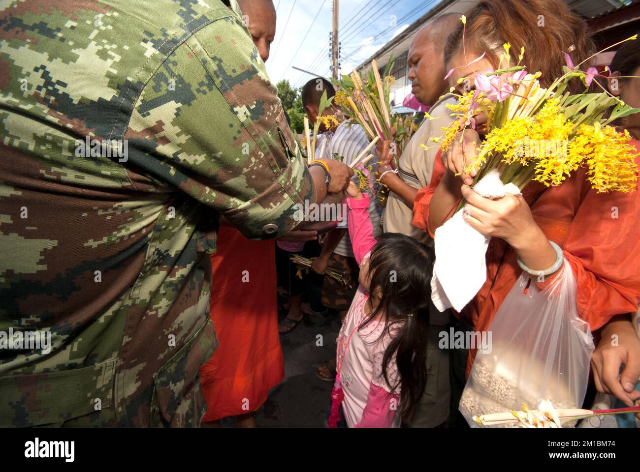 Many Thai people Give Flowers to Buddhist Monks for alms in The Tak Bat ...