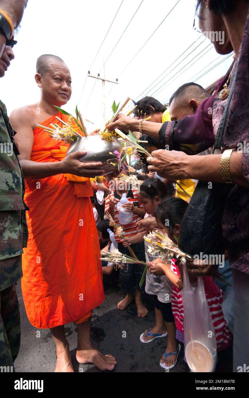 Many Thai people Give Flowers to Buddhist Monks for alms in The Tak Bat ...