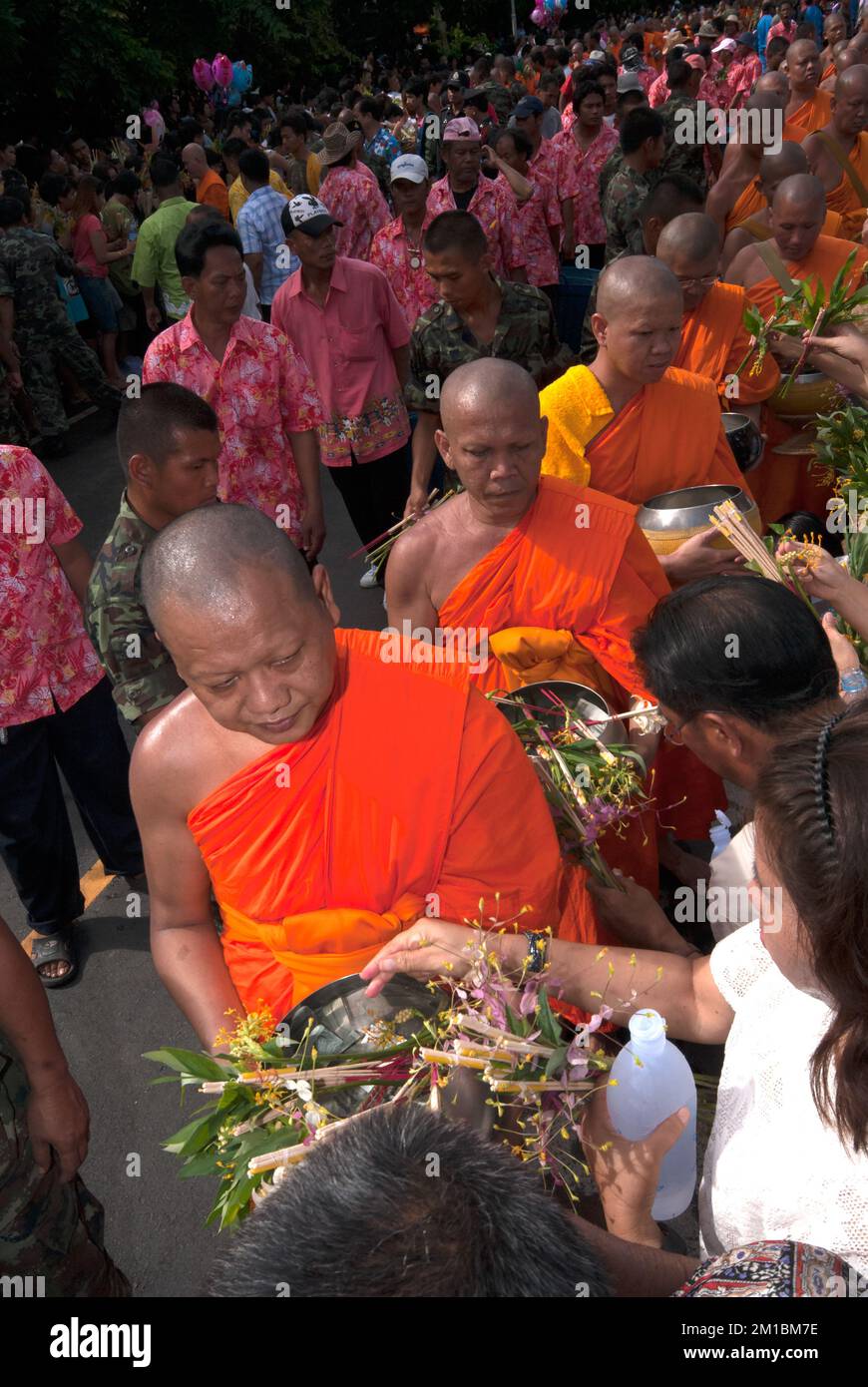 Many Thai people Give Flowers to Buddhist Monks for alms in The Tak Bat ...