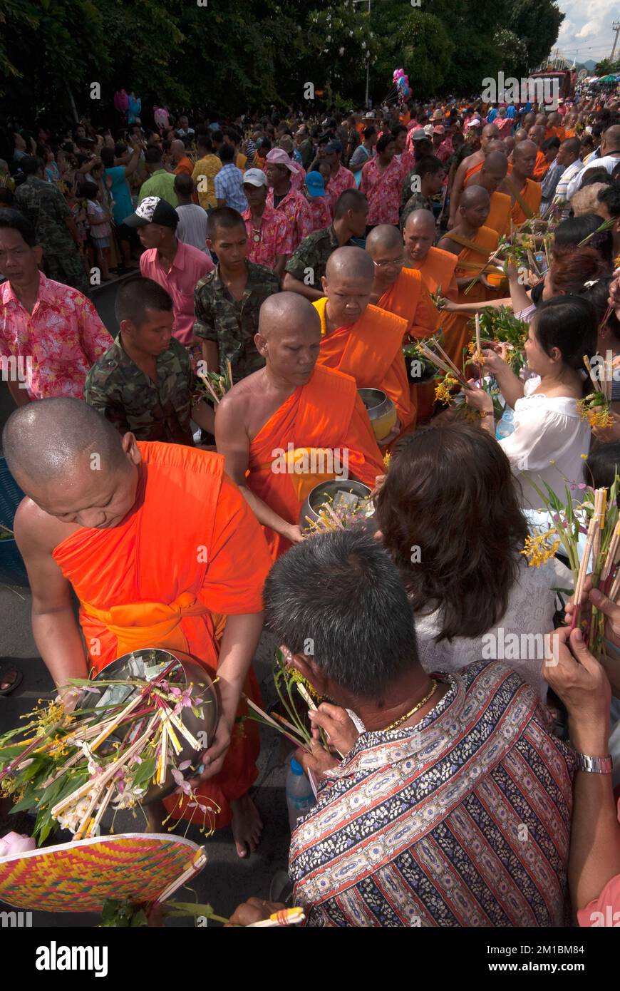 Many Thai people Give Flowers to Buddhist Monks for alms in The Tak Bat ...