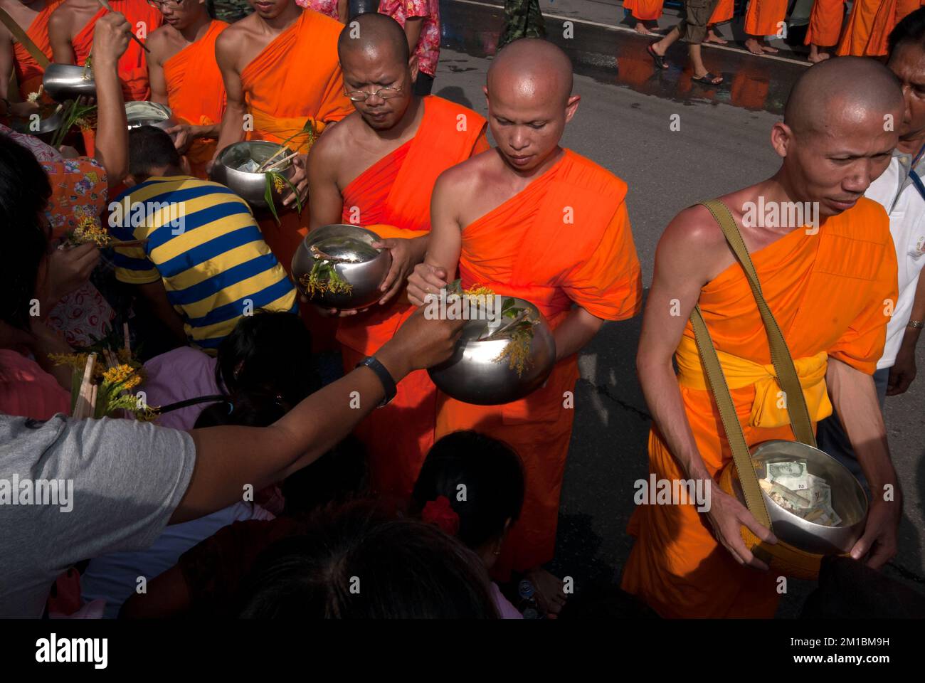 Many Thai people Give Flowers to Buddhist Monks for alms in The Tak Bat ...
