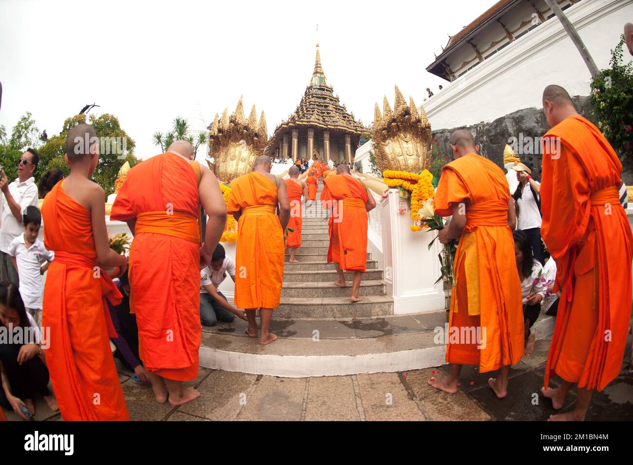 Row of Monks walking to Pagoda in Tak Bat Dok Mai Festival (give ...