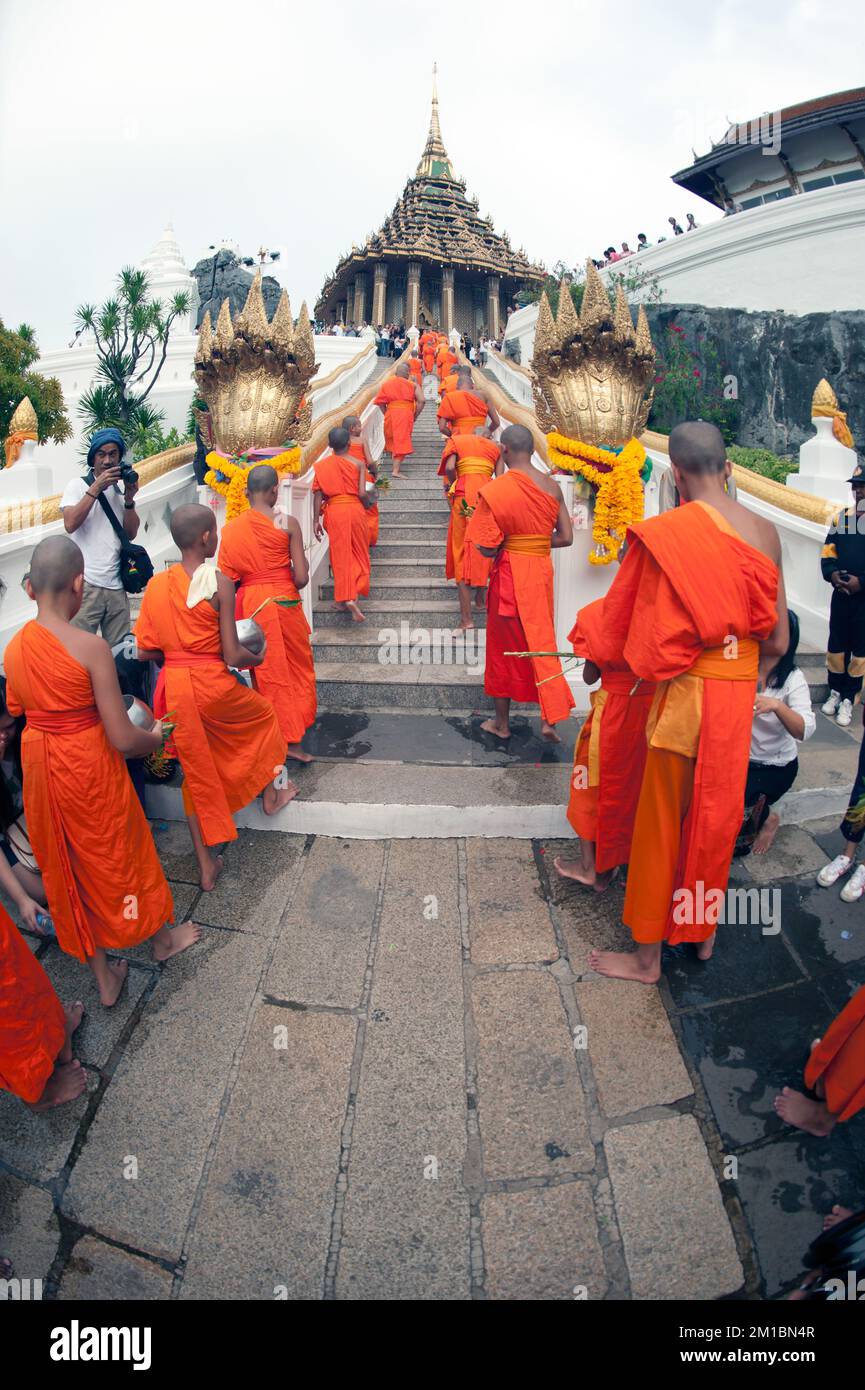 Row of Monks walking to Pagoda in Tak Bat Dok Mai Festival (give ...