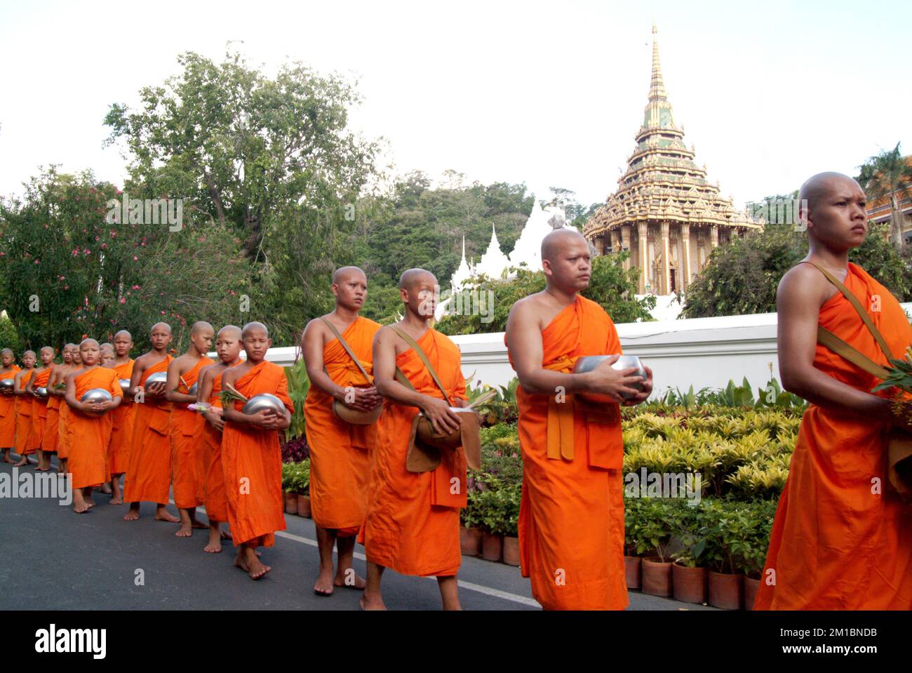 Row of Monks walking to Pagoda in Tak Bat Dok Mai Festival (give ...