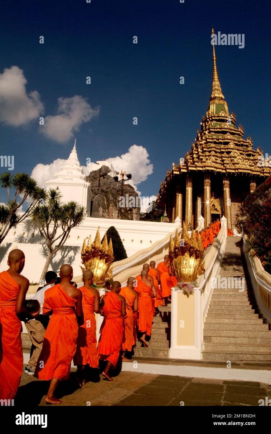 Row of Monks walking to Pagoda in Tak Bat Dok Mai Festival (give ...