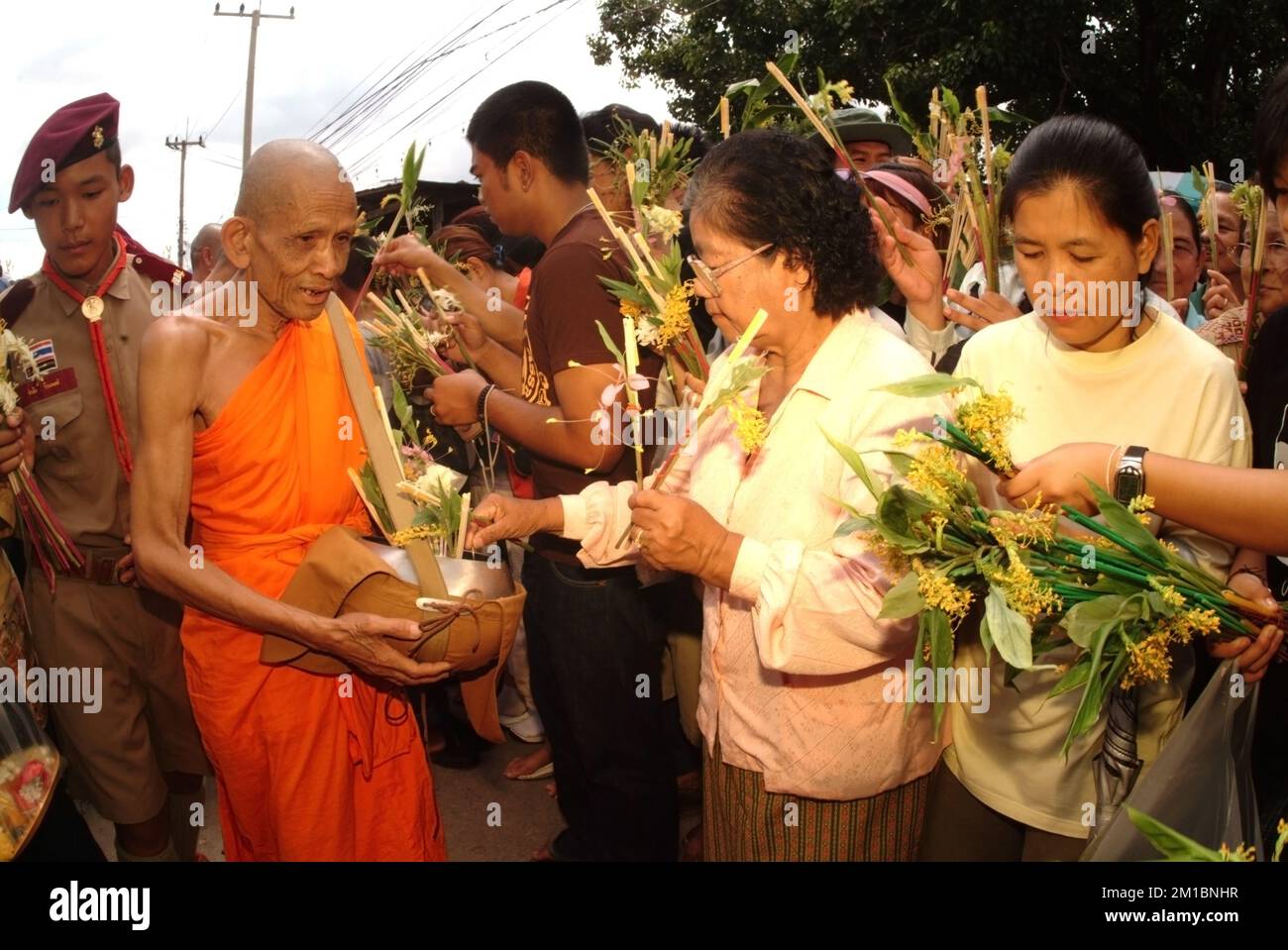 Row of Monks walking to Pagoda in Tak Bat Dok Mai Festival (give ...