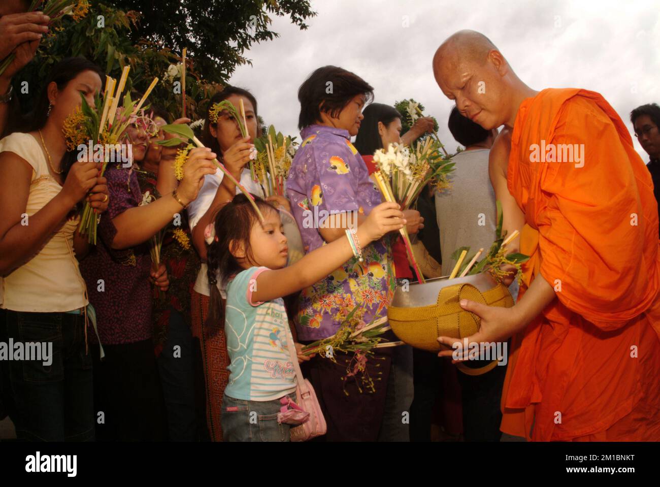 Row of Monks walking to Pagoda in Tak Bat Dok Mai Festival (give ...
