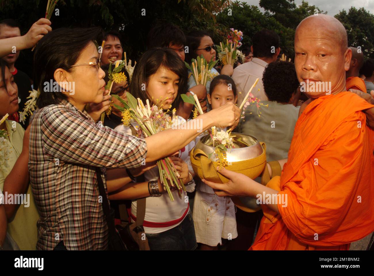 Row of Monks walking to Pagoda in Tak Bat Dok Mai Festival (give ...