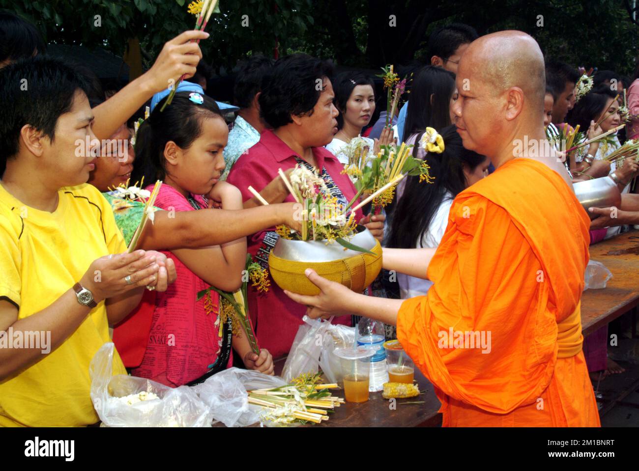 Row of Monks walking to Pagoda in Tak Bat Dok Mai Festival (give ...