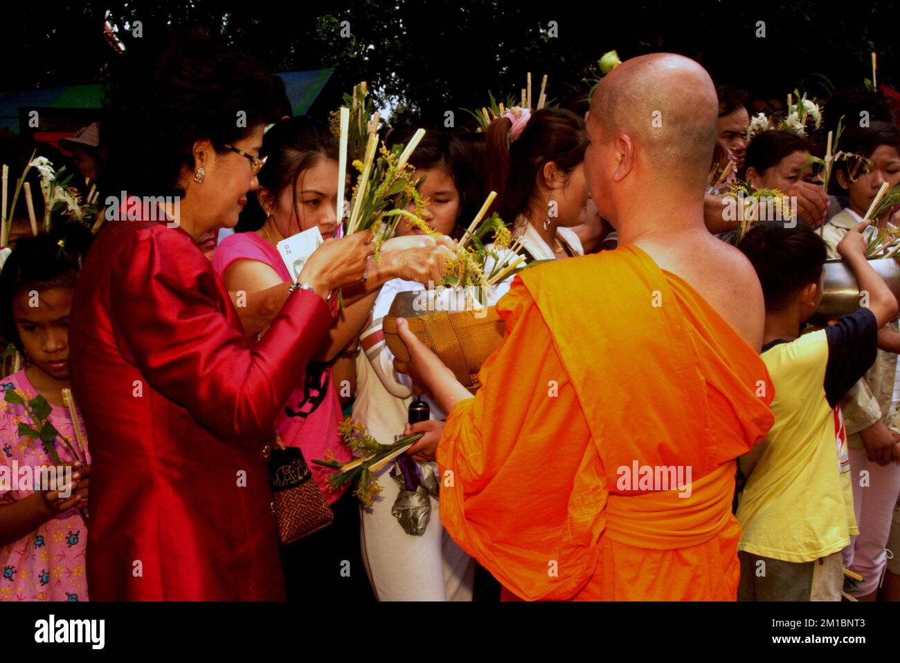 Row of Monks walking to Pagoda in Tak Bat Dok Mai Festival (give ...