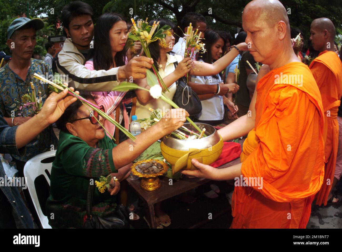 Row of Monks walking to Pagoda in Tak Bat Dok Mai Festival (give ...