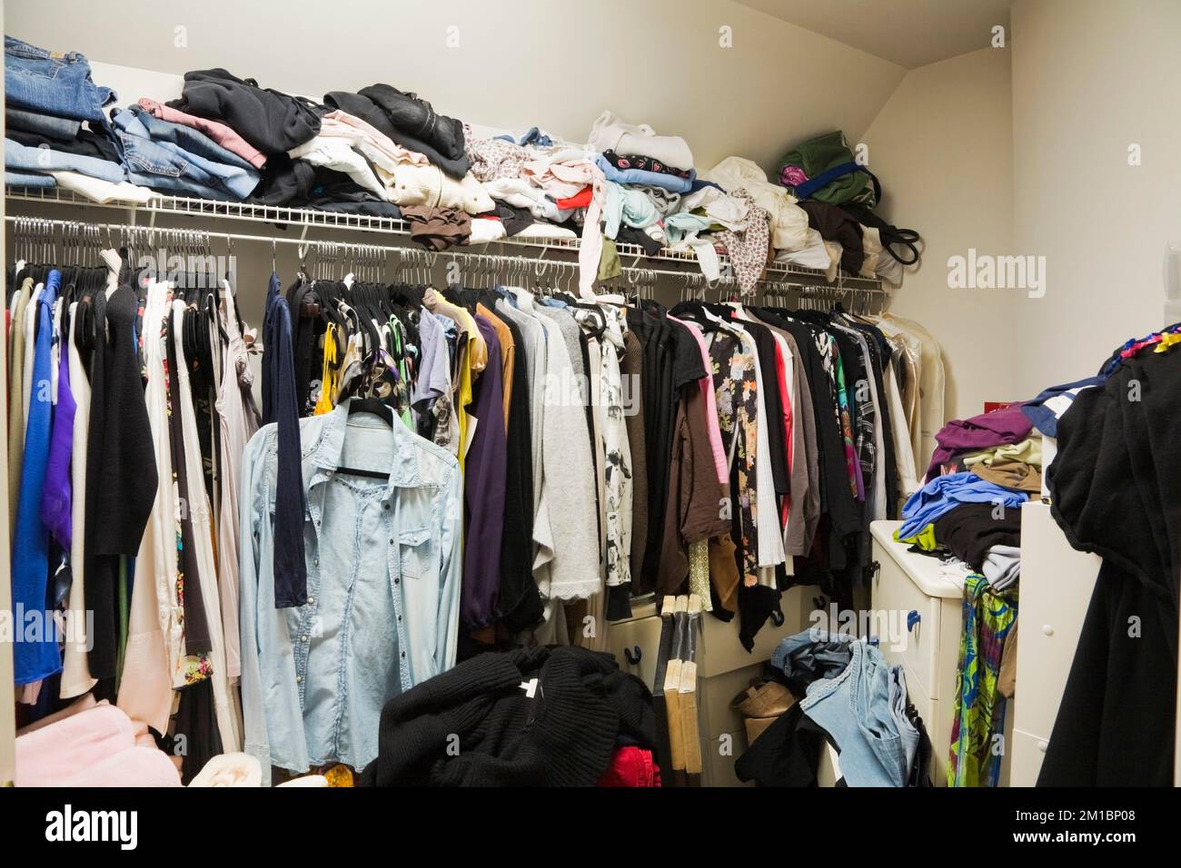 Walk-in closet filled with woman's clothes inside a luxurious cottage ...