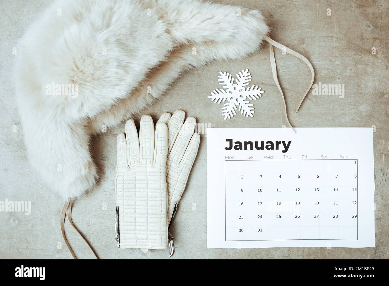 winter flat lay with fur hat, gloves and january calendar Stock Photo ...