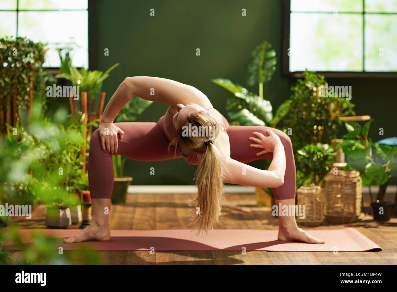 modern 30 years old woman at modern green home doing yoga Stock Photo ...