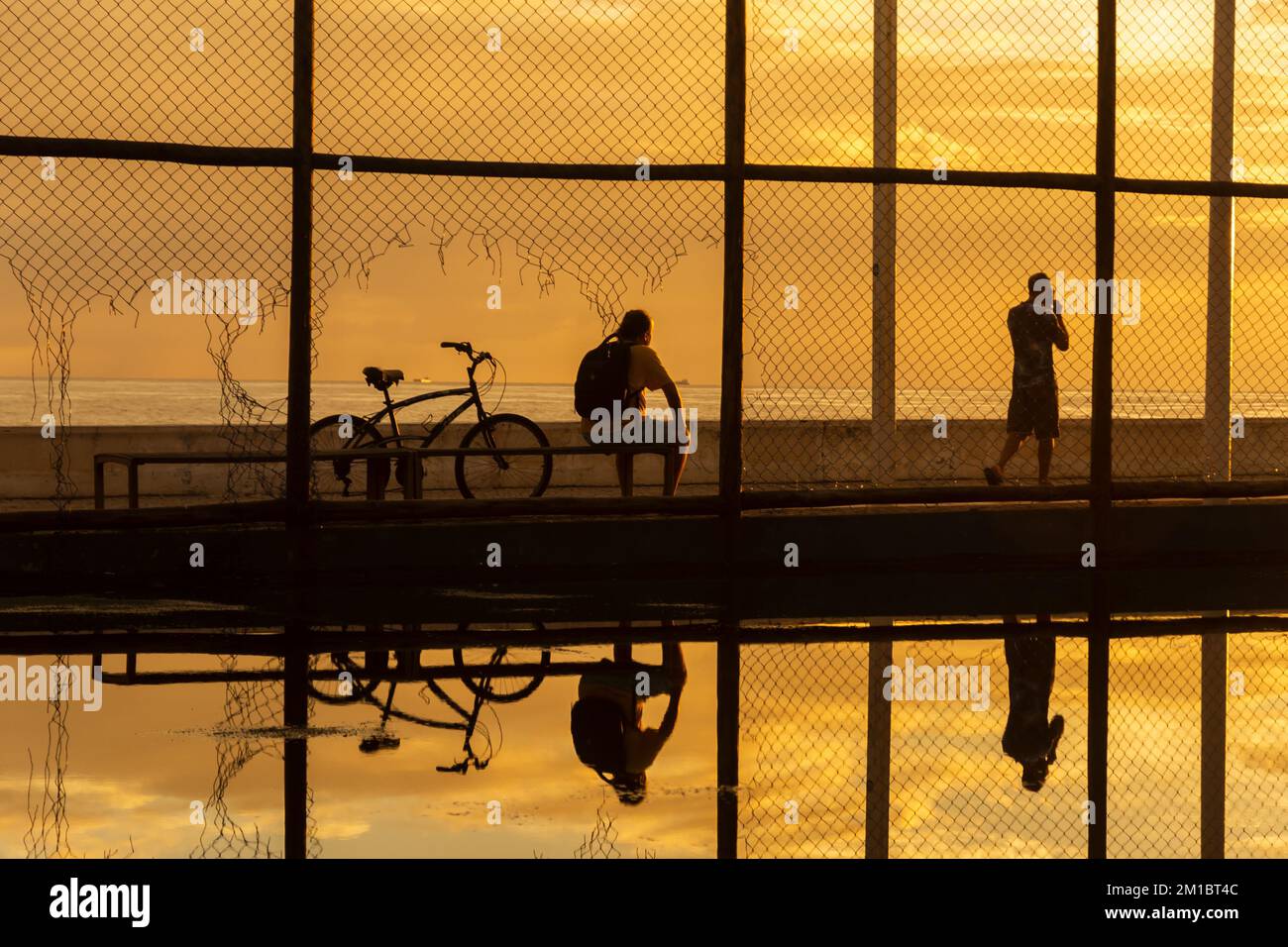 Silhouette of people exercising on the edge of Rio Vermelho beach in ...