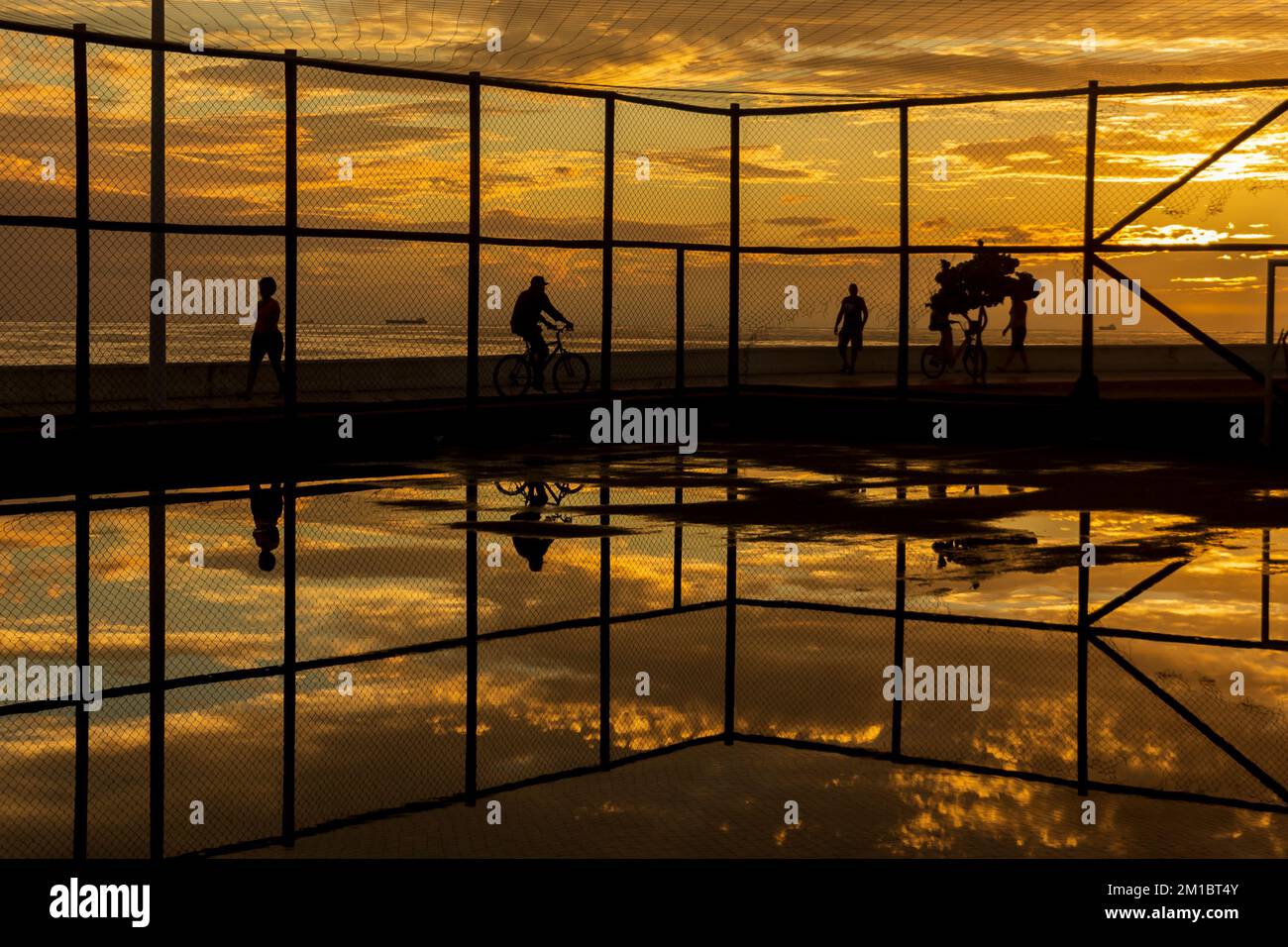 Silhouette of people exercising on the edge of Rio Vermelho beach in ...