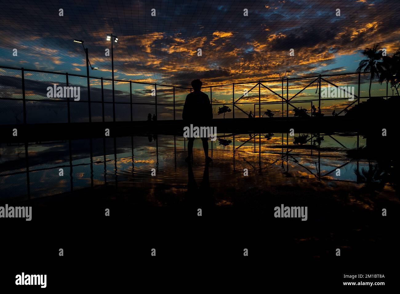 Silhouette of a man on the sports court of Rio Vermelho beach in ...