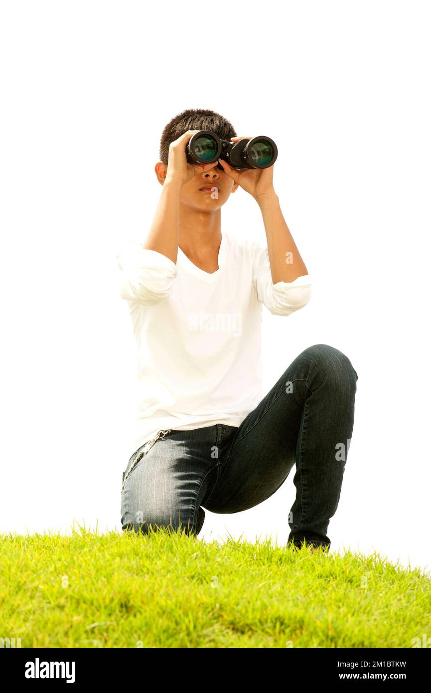Asian young boy sit and seeking Binoculars Stock Photo - Alamy