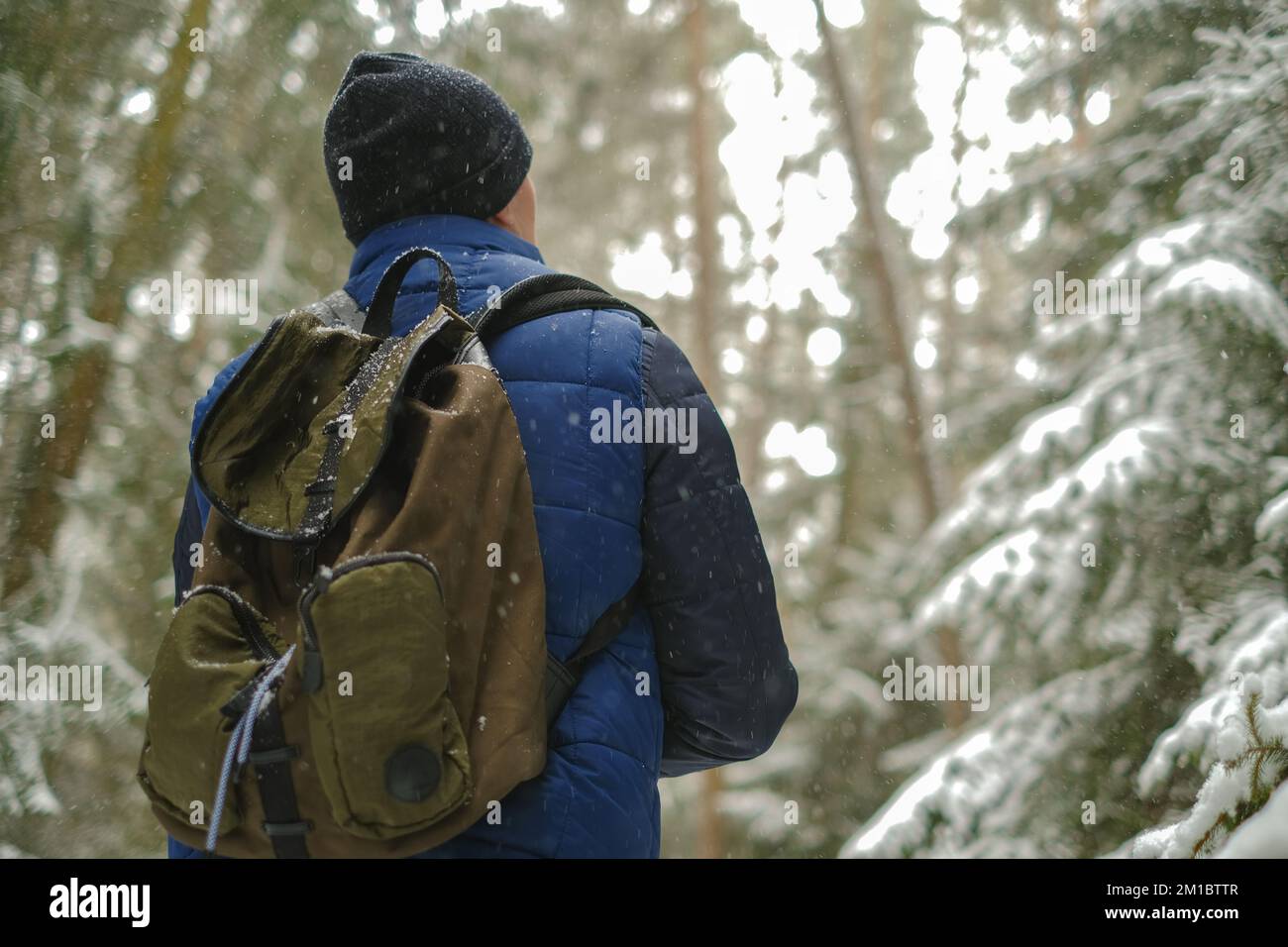hiking in Winter season.man with a backpack in snowy weather. Snowfall ...