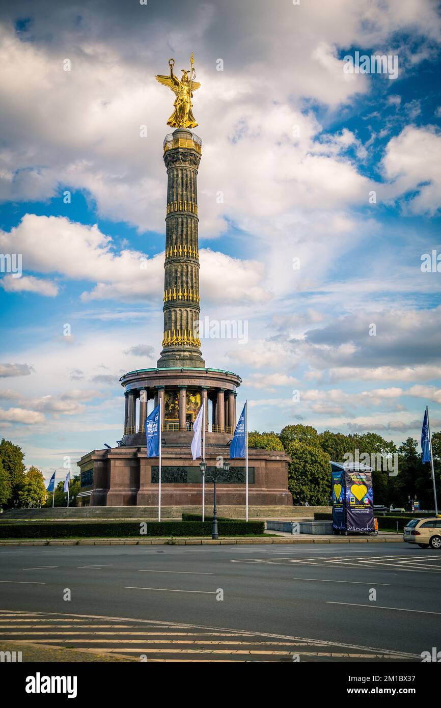 A vertical shot of the Victory Column Monument in Berlin against blue ...