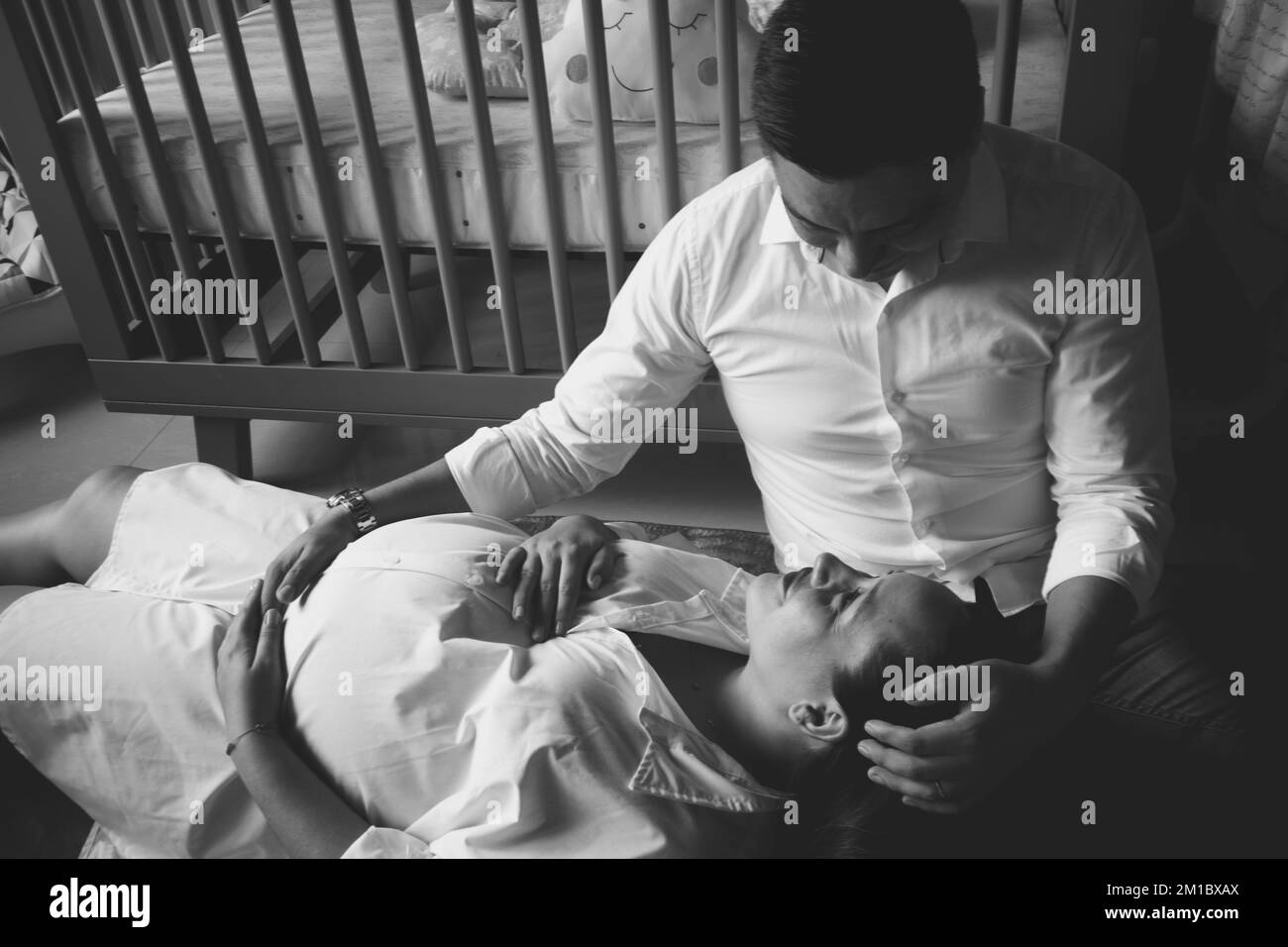 A grayscale shot of a couple expecting a baby, she is pregnant Stock ...